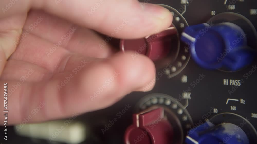 Adjusting the input and high pass dial of a vintage analog recording ...