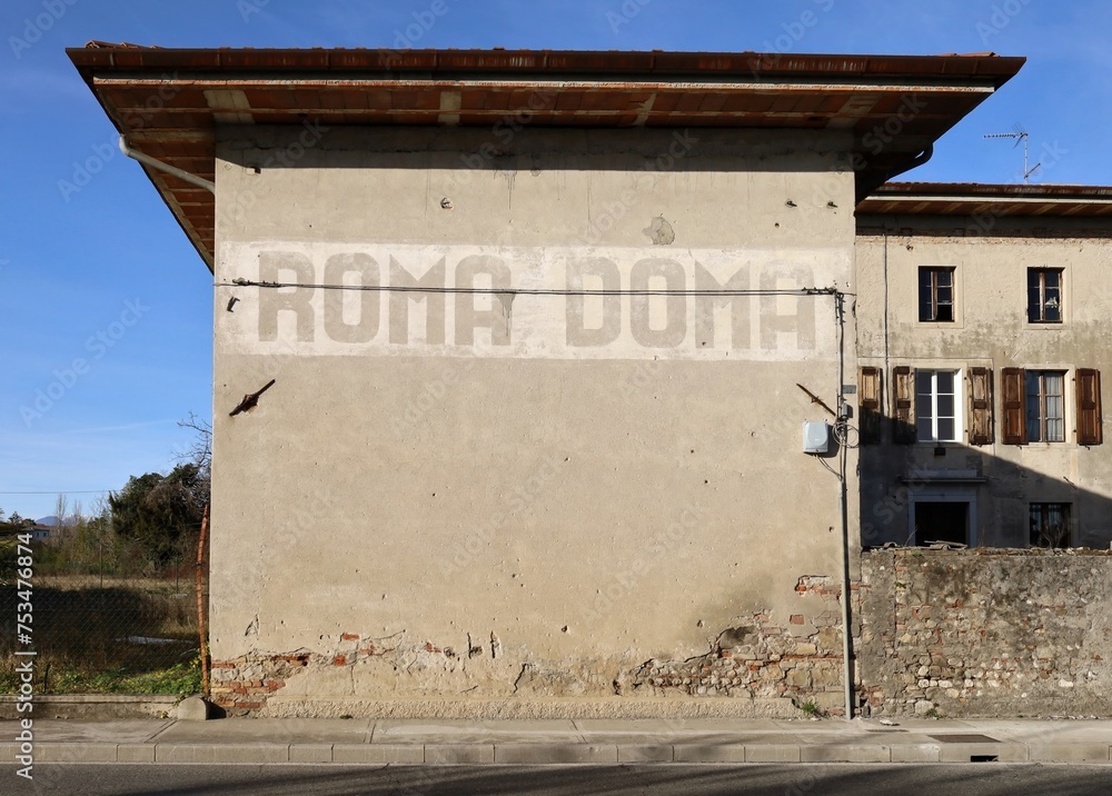 Udine, Italy. February 13, 2024. Historical propaganda fascist writing ...