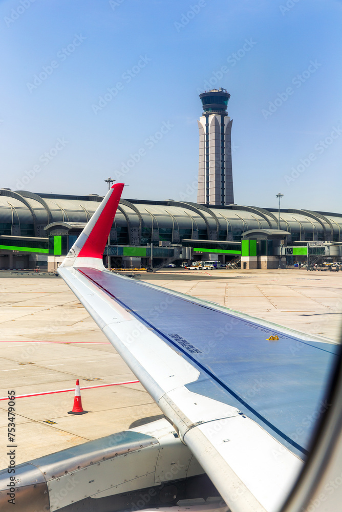 Muscat airport control tower. View from an airplane window. Boarding ...