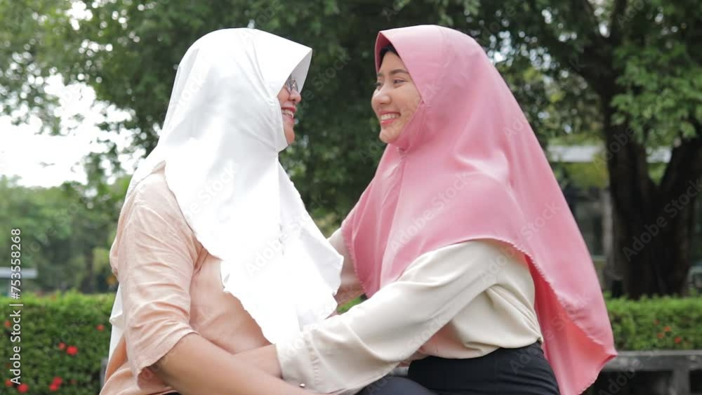 Muslim mother and daughter express their love, hugging each other in an ...