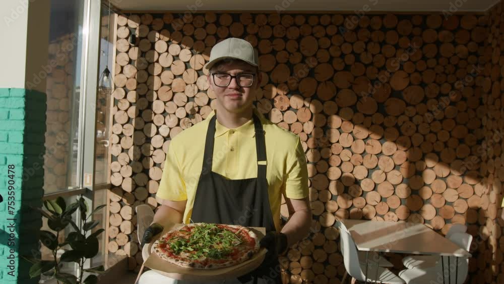 Embracing inclusivity, a cafe worker with neurodiversity holding pizza ...