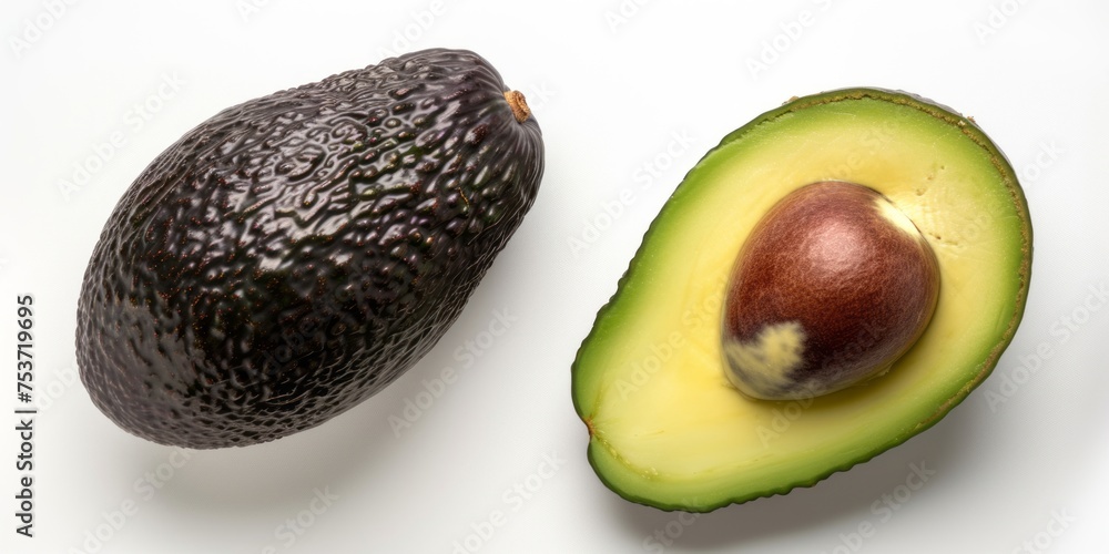 A ripe avocado is presented on a white background, showcasing muted ...