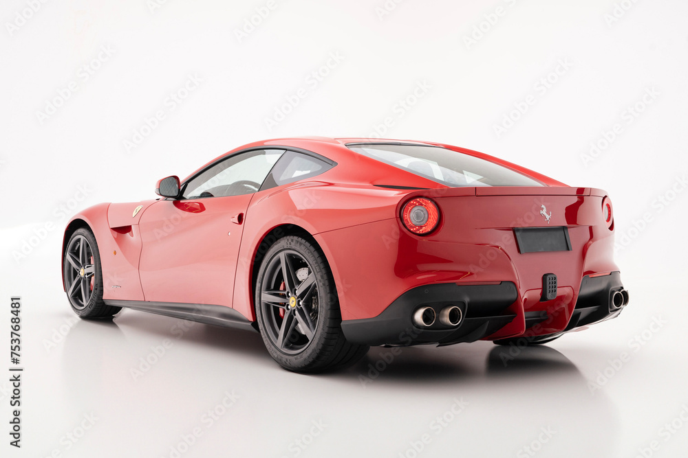 Red Ferrari F12 Berlinetta rear end three quarters view isolated on ...