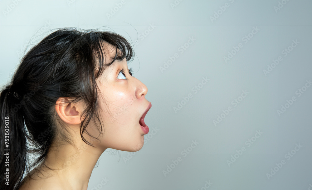 On the side Funny face asian girl with messy hair shocked big eyes wide ...
