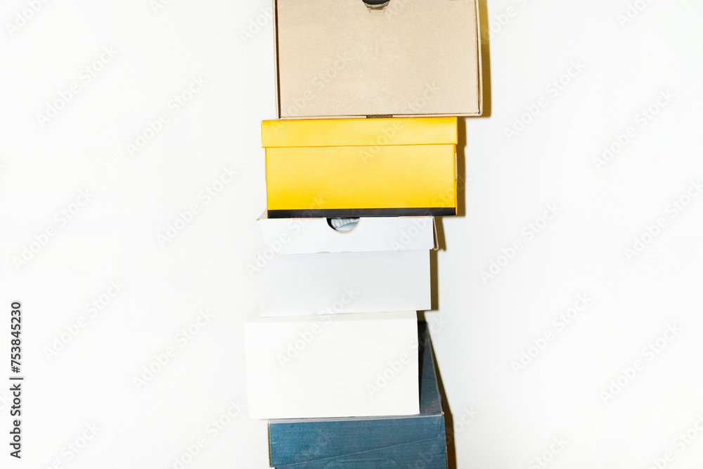 Colourful shoe boxes in towers / stacks with hard direct flashlight ...