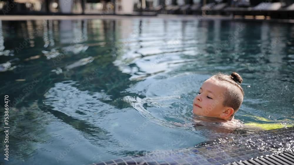 Little boy child learning swimming by himself. Learning to move legs ...