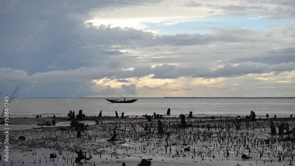 Morning view of fishing boats lined up at Alorkol Beach, Sundarbans. It ...