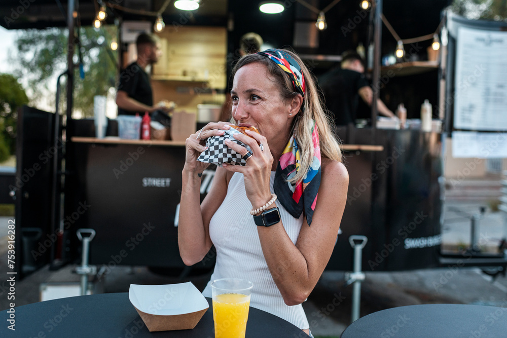 Customer eating smash burger and french fries in a food truck Stock ...
