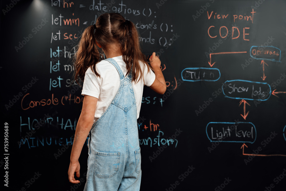 Back view of a school girl wear bib, the kid standing and writing the ...