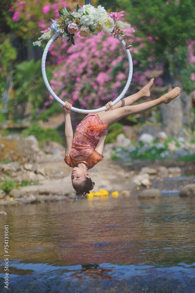 Beautiful Asian girl performing show aerial hoop or aerial ring in ...