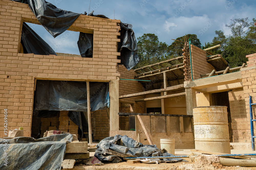 Closer look of a messy construction site of an adobe bricks house, near ...