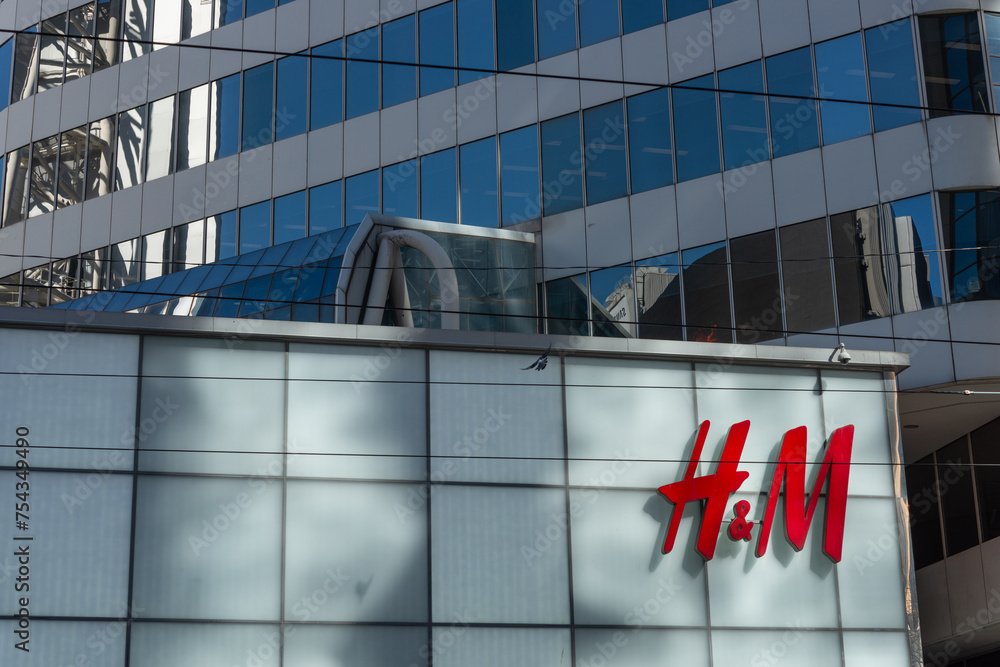 exterior building facade and sign of H&M, a clothing store chain ...