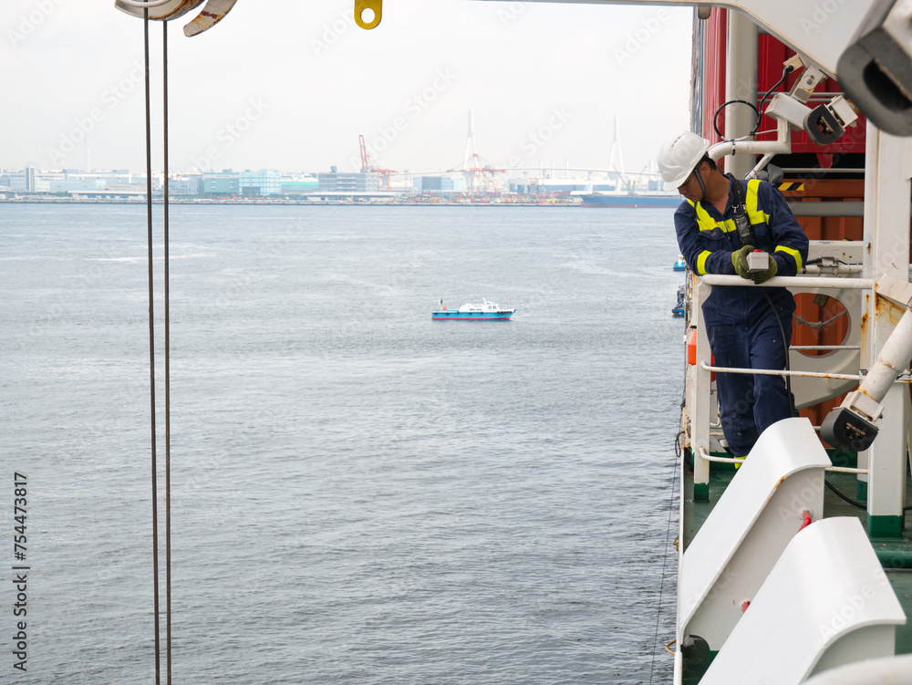 Seaman crew member of cargo vessel equipped with personal protective ...
