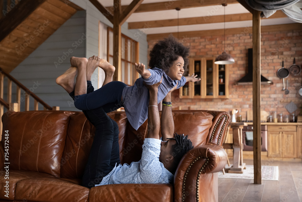 African father raise on outstretched strong arms his little 6s daughter ...