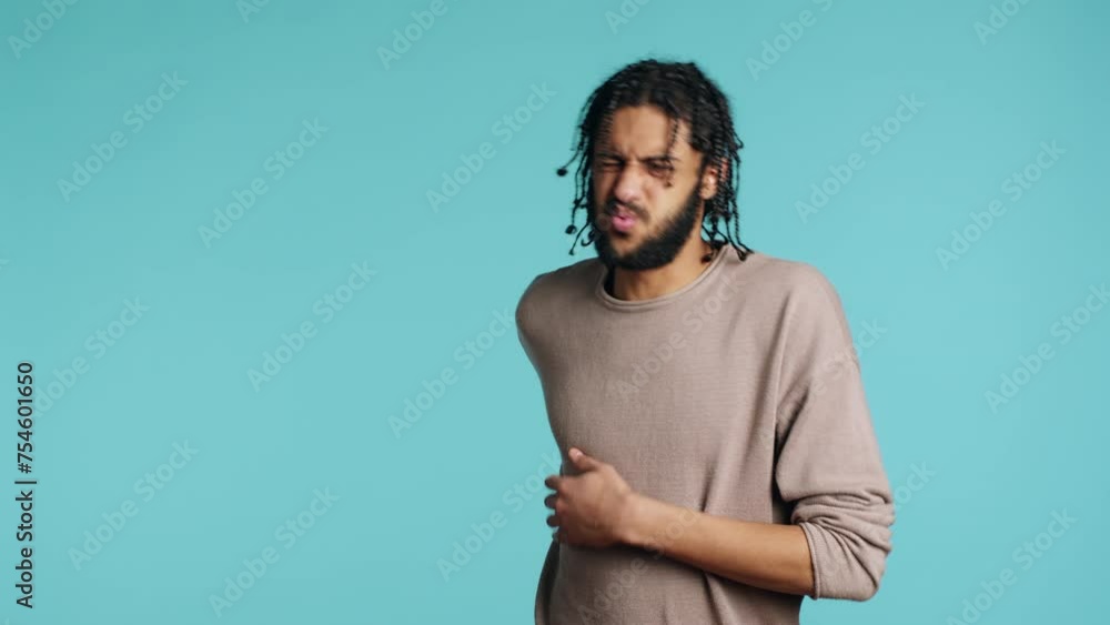 Hurt middle eastern man screaming from pain, suffering from back injury ...