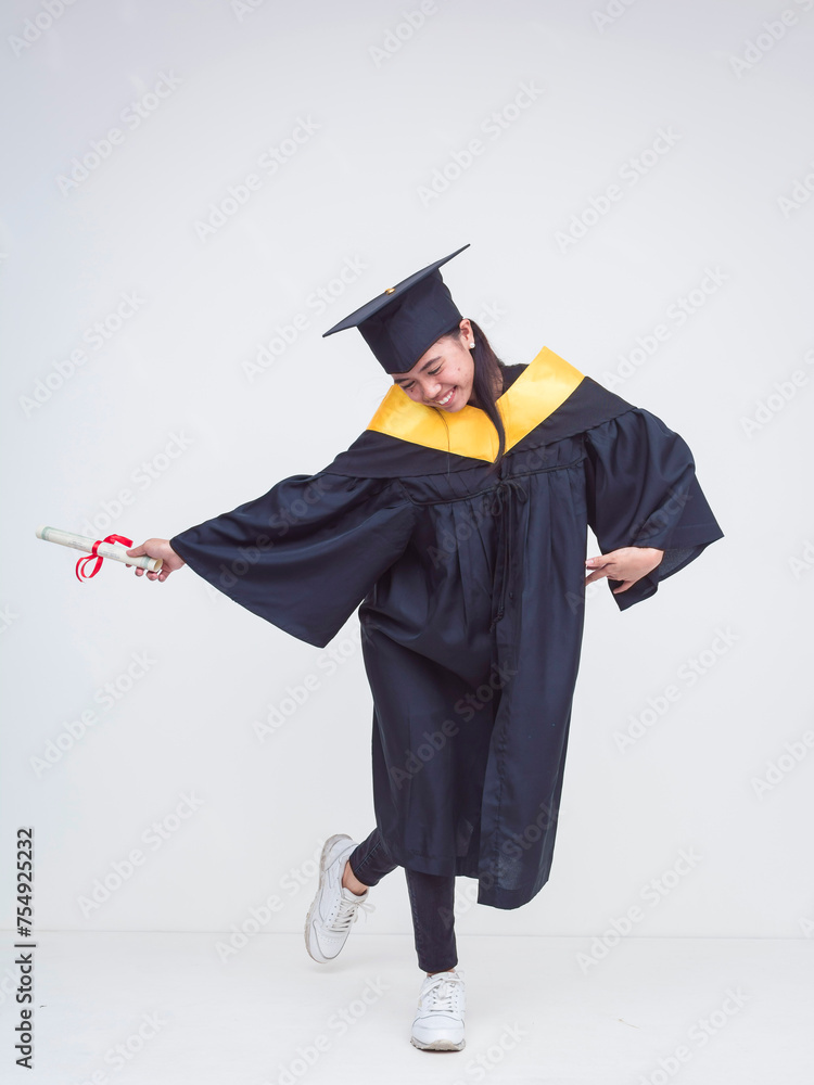 A happy female graduate of bachelor of science holding her diploma ...