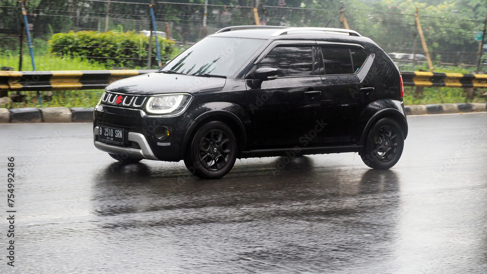 Black color Suzuki Ignis in rainy day, at TB Simatupang Street, South ...