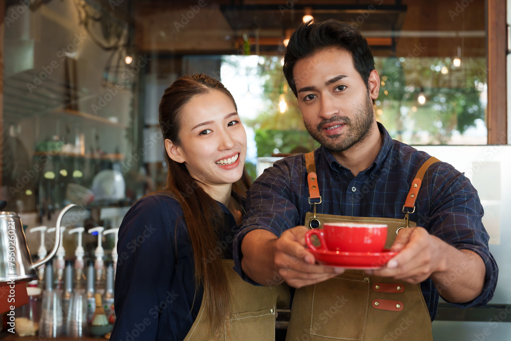 Indian man and beautiful Asian woman are partners own a bakery together ...