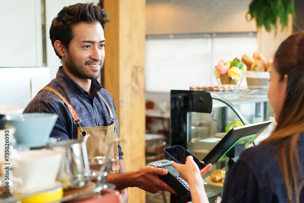 Male cafe employees of various nationalities holding credit card ...