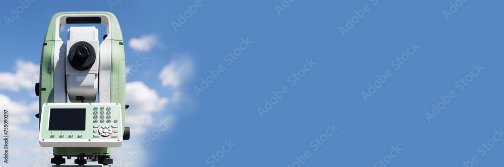 Total station against a background of blue sky. Geodetic equipment for ...