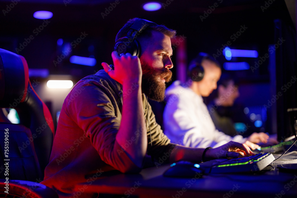 Worried bearded man gamer playing PC video game on a cybersport ...