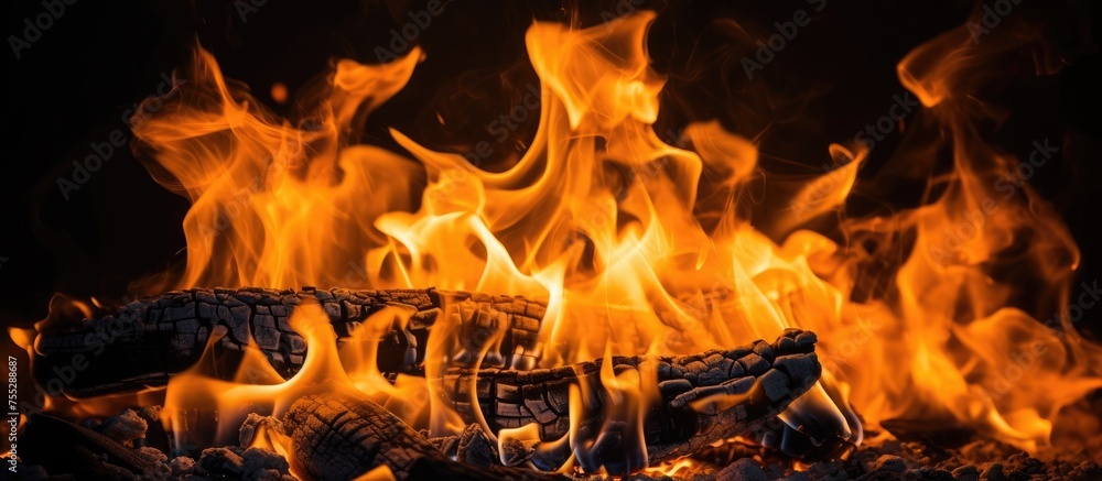 A close-up view of a fiery blaze with multiple flames dancing and ...