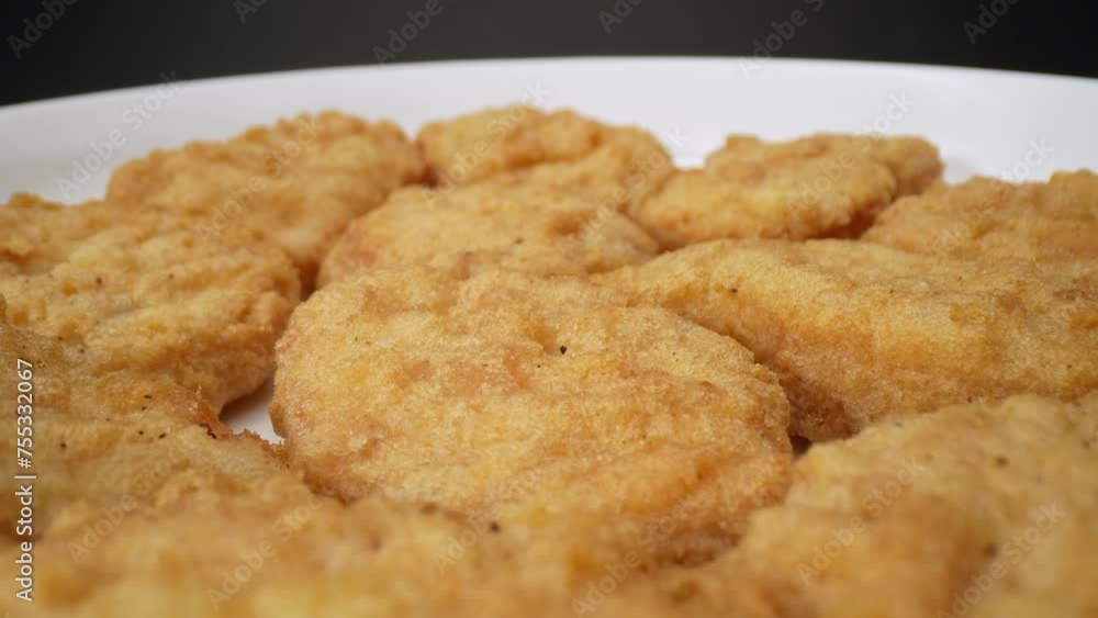 Chicken nuggets made by cutting or grinding chicken, mixed with ...