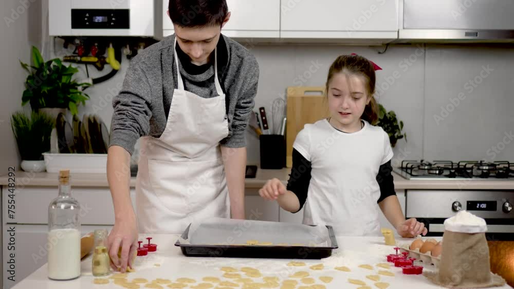 Cookie making. Happy children put dough ready in baking tray. Cute boy ...