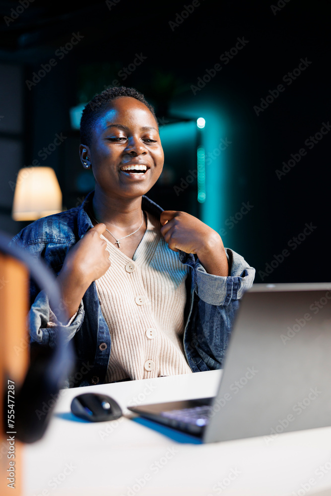Black woman smiling wide and happily while using a digital personal ...