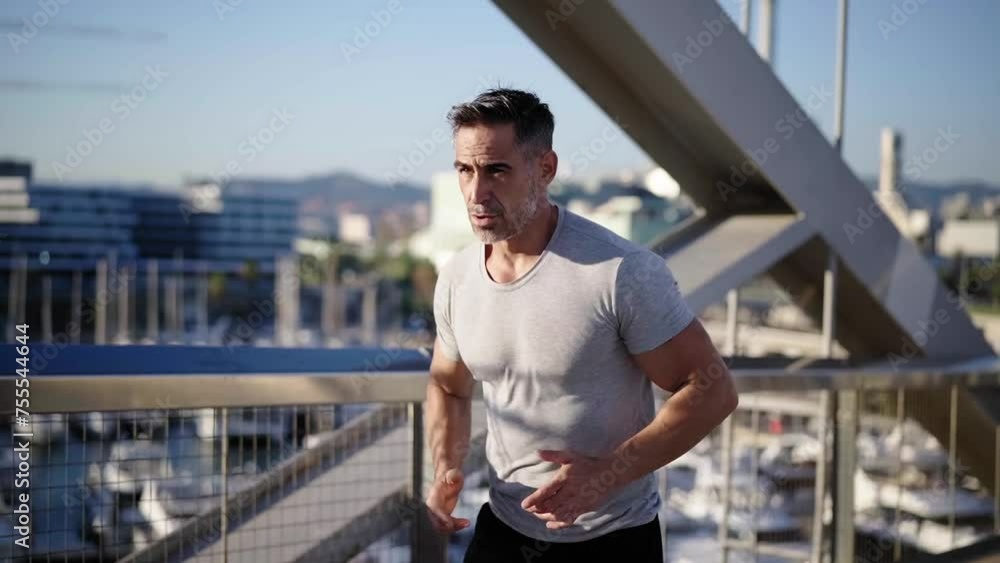 Middle-aged caucasian man with fitness habits running in the morning ...