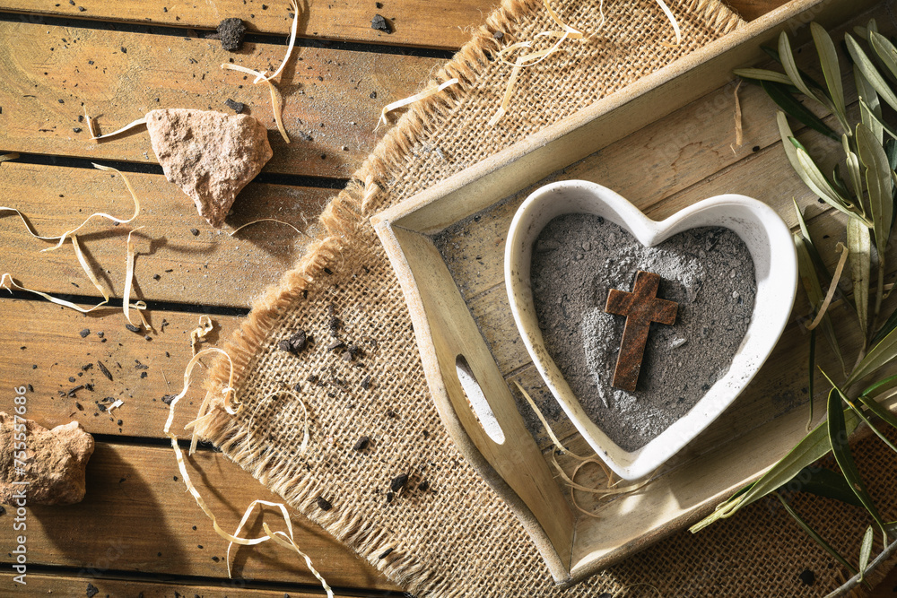 Heart-shaped container with ashes and wooden cross top view Stock Photo ...