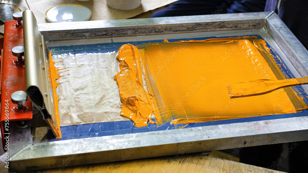 silkscreen printing. plastisol ink (paint) on a mesh screen frame ...