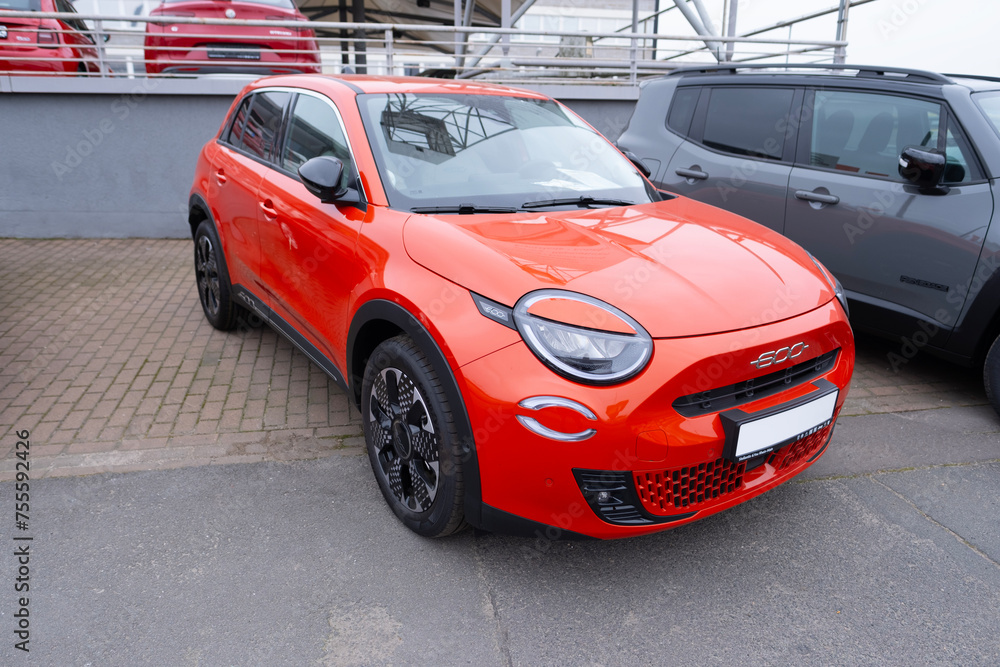 red electric Fiat 600 Е car parked in parking lot, Compact crossover ...