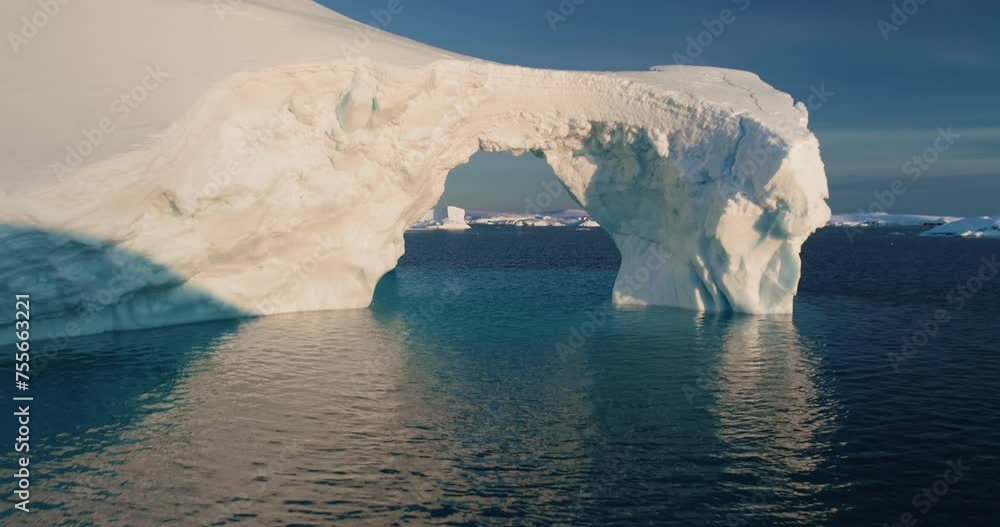 Melted ice cave arch hole iceberg towering arctic ocean. Big glacier ...