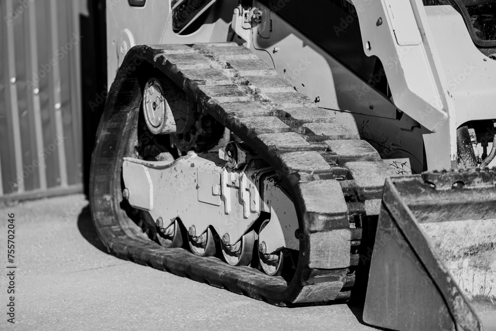 Black and white photo of compact loader track skid loader side view of ...