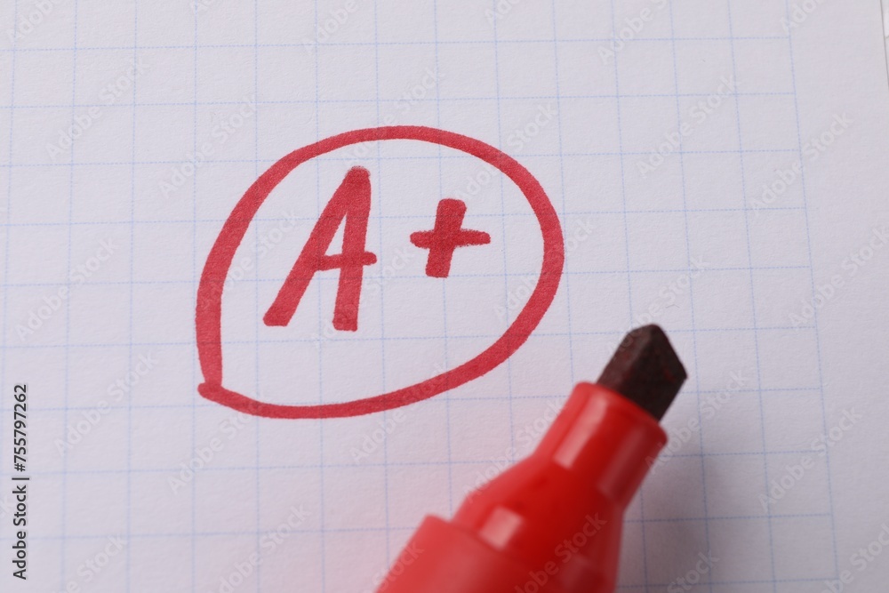 School grade. Red letter A with plus symbol on notebook paper and ...