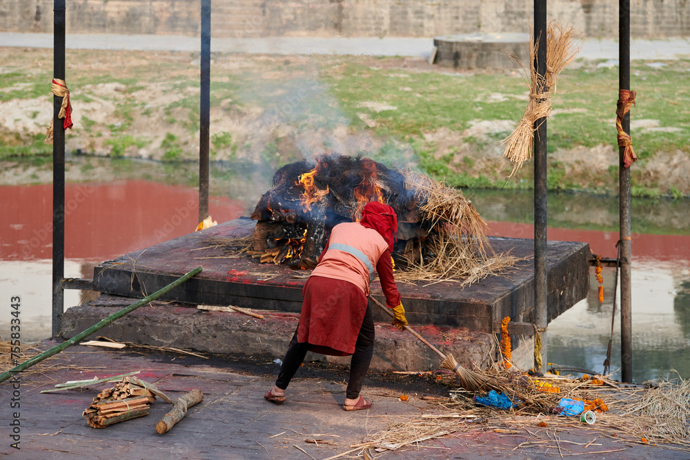 Staff employee of Pashupatinath Temple complex overseeing for funeral ...