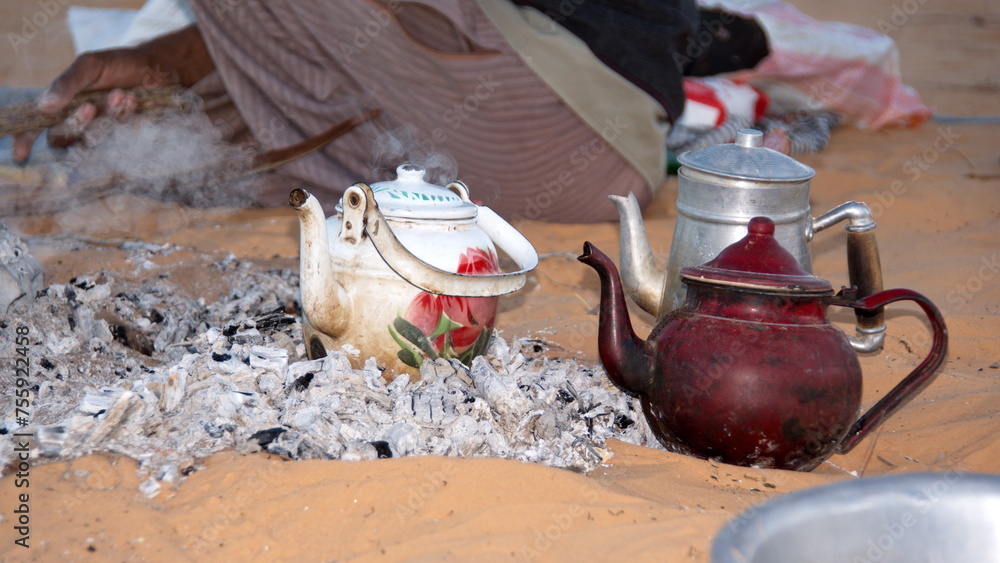 Tea kettle on the cooking fire during a camel trek in the Sahara Desert ...