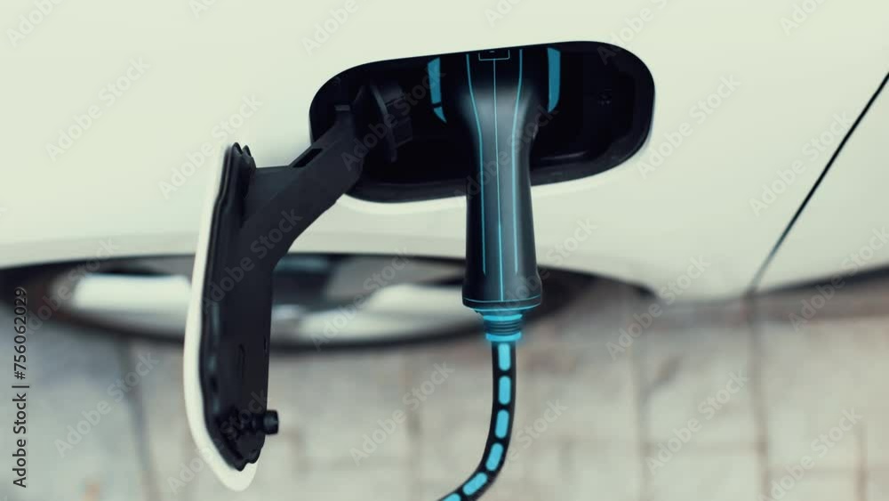 Top view EV charger plugged into electric car for electric recharging ...