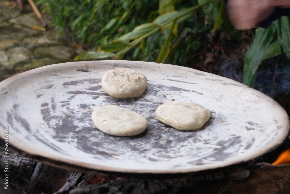 A tlacoyo being prepared in a traditional kitchen in Mexico. Typical ...