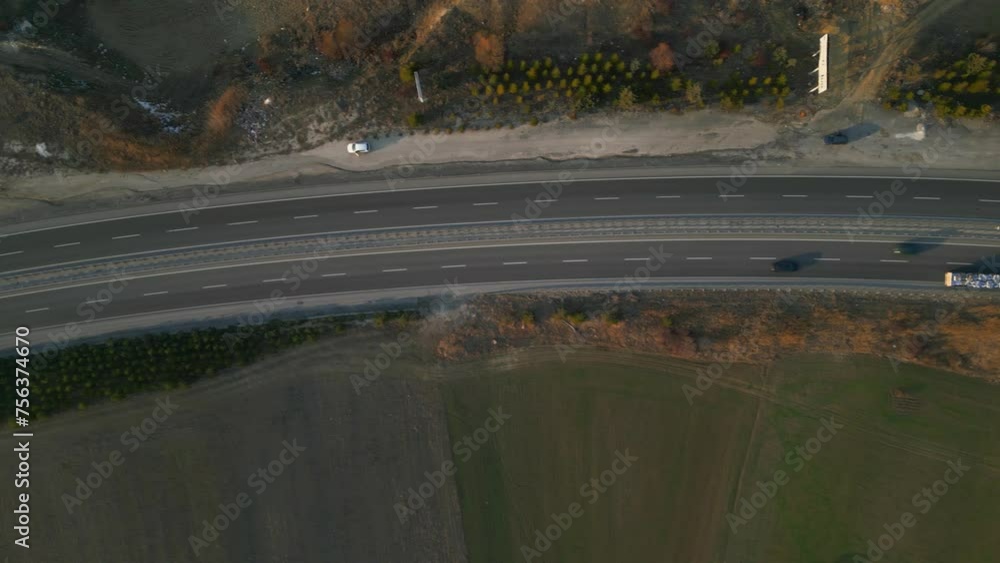 Birds eye view of vehicles moving along a bustling highway surrounded ...