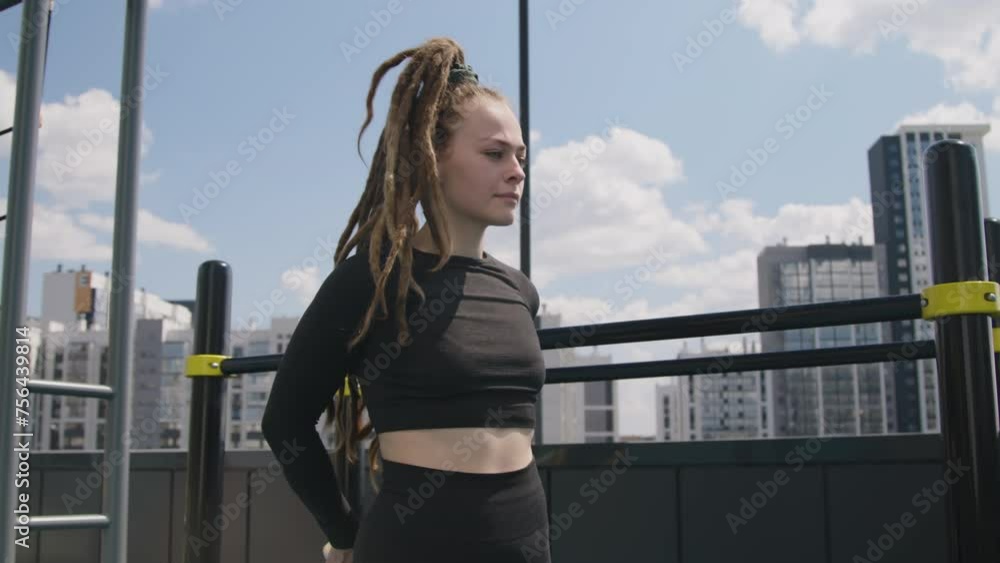 Side tilt footage of Caucasian woman with dreadlocks and lean body ...