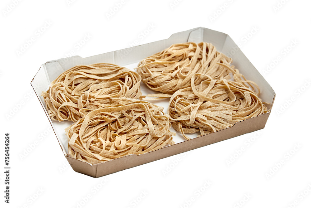 Whole grain pasta tagliatelle isolated on white background. Tagliatelle ...