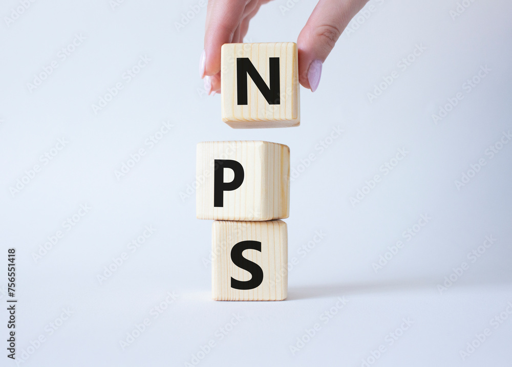 NPS - Net Promoter Score symbol. Wooden cubes with words NPS ...