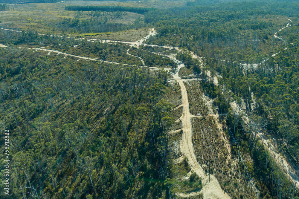 Drone aerial photograph of telephone lines and a dirt track running ...