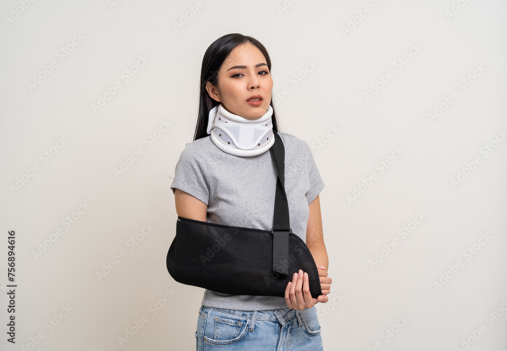 Depressed upset woman suffering from pain. Broken arm. Asian woman put ...