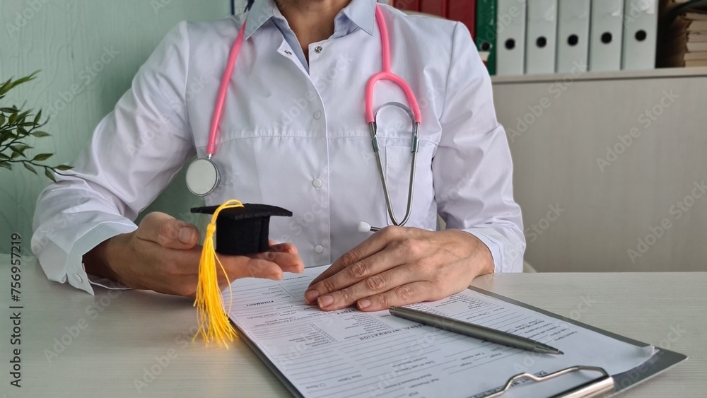 Doctoral study student with graduation hat in hospital room. Smart ...