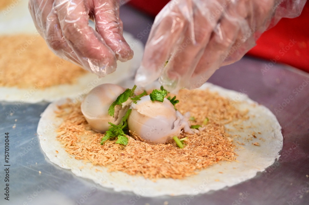 A vendor at the Ningxia Night Market in Taipei City, Taiwan, sprinkles ...