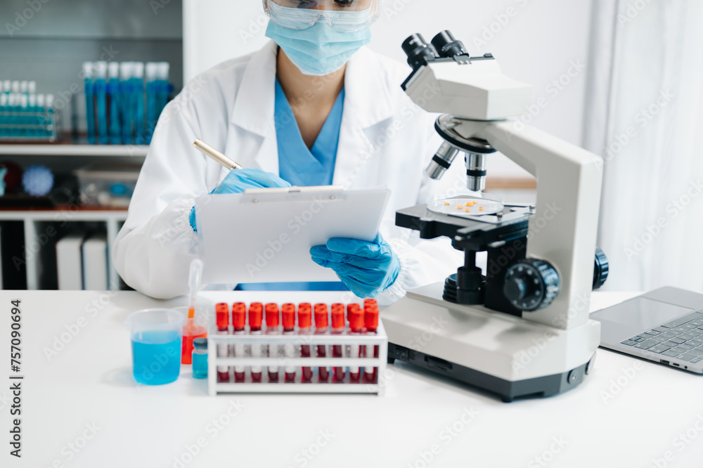 Scientist mixing chemical liquids in the chemistry lab. Researcher ...