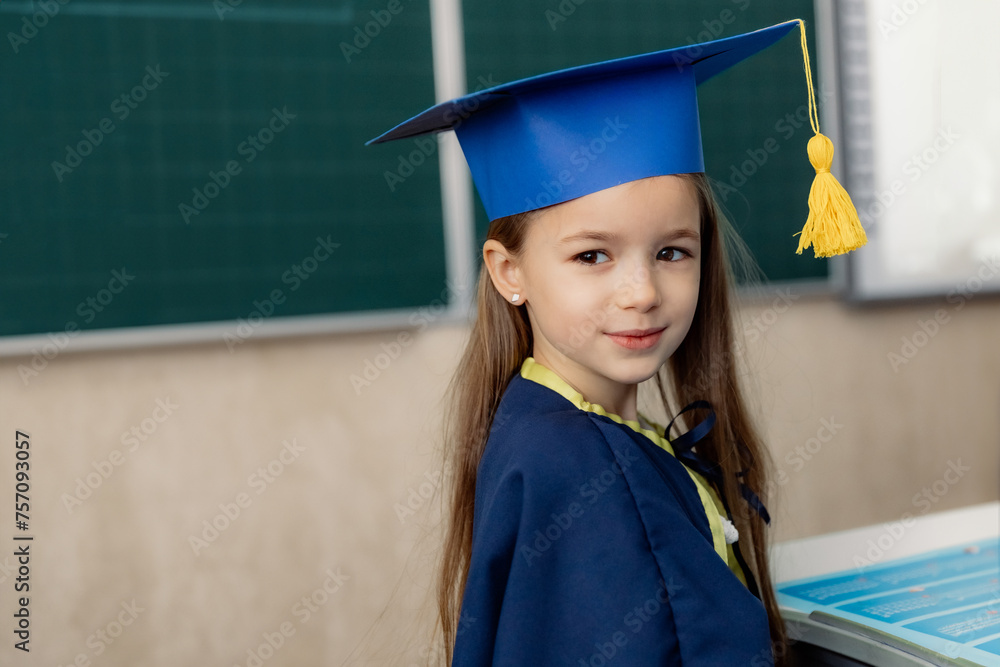 first grade girl. portrait of a first grader in a festive hat posing ...